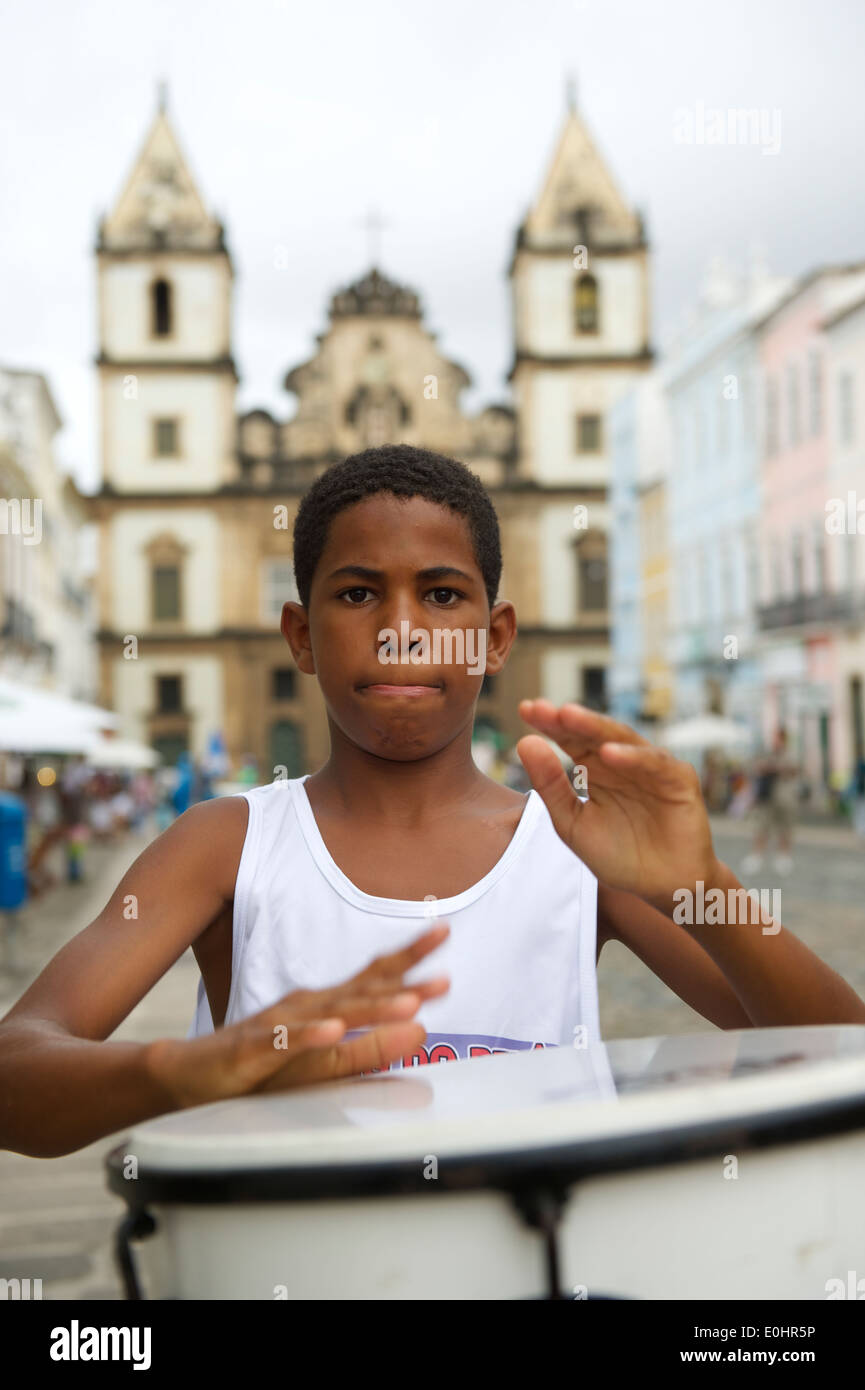 SALVADOR, BRAZIL - OCTOBER 15, 2013: Brazilian child stands drumming in ...