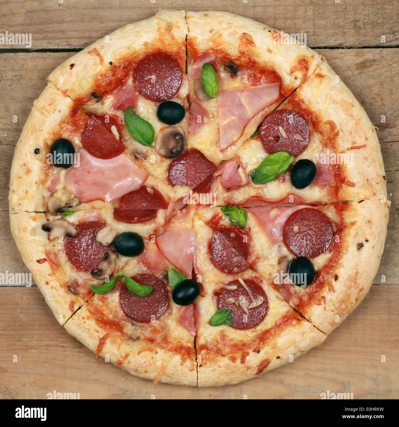 Freshly baked pizza with ham, pepperoni and mushrooms Stock Photo - Alamy