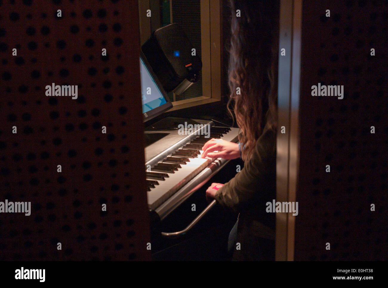 Teenage girl playing piano at EMP Museum, Seattle, Washington State ...