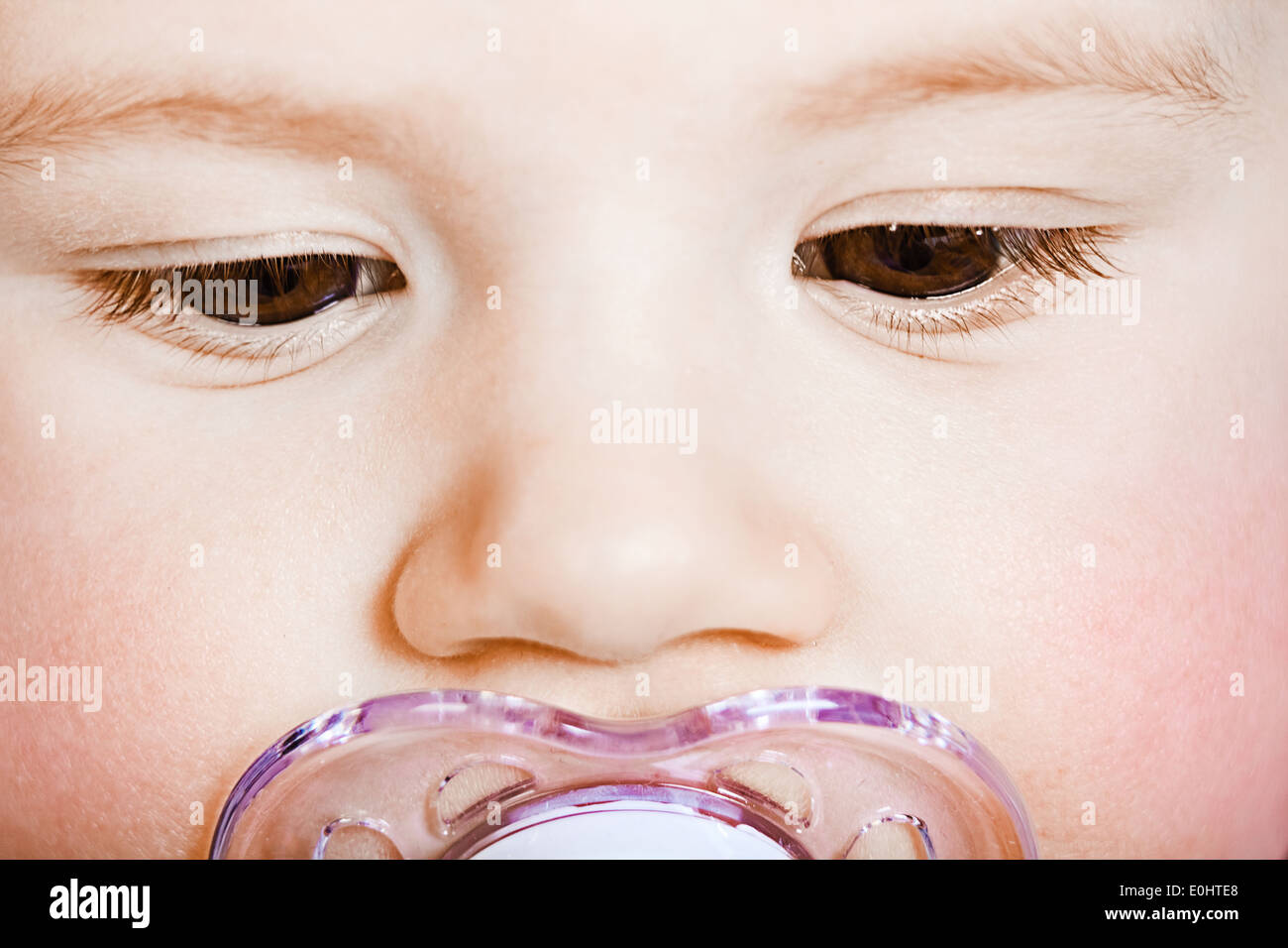 sad face baby with pacifier closeup. macro Stock Photo - Alamy