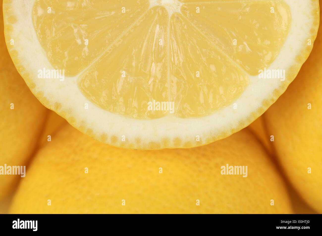 Closeup of a sliced fresh lemon, decorated with more lemons Stock Photo ...