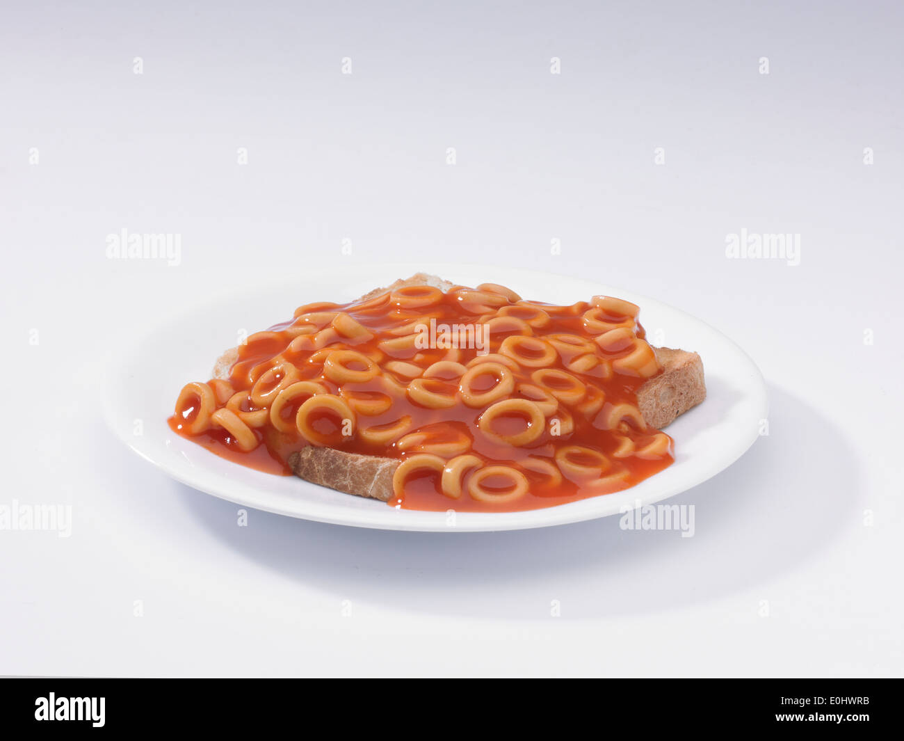 a serving of spaghetti hoops on toast on a white plate on a white ...