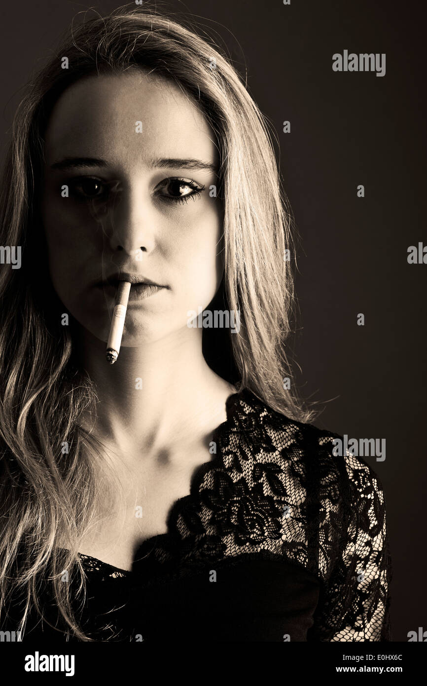 Portrait of a young woman with cigarette Stock Photo - Alamy