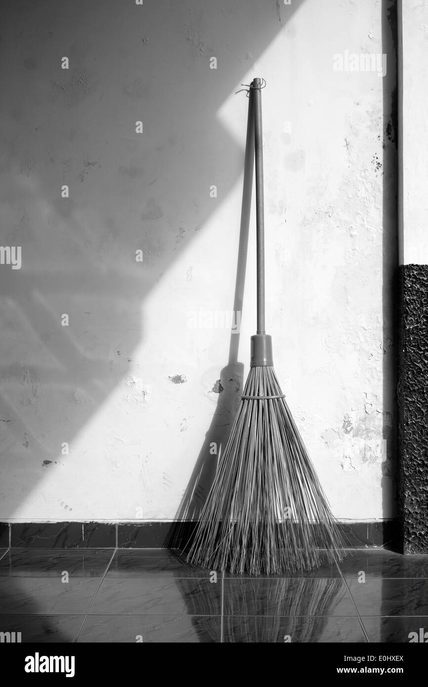 traditional besom type broom standing against the wall of a house in a ...