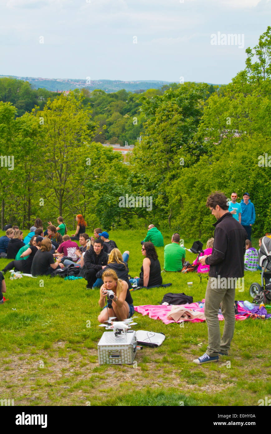 Man flying and a woman taking photo of a drone, Parukarka park, Zizkov ...