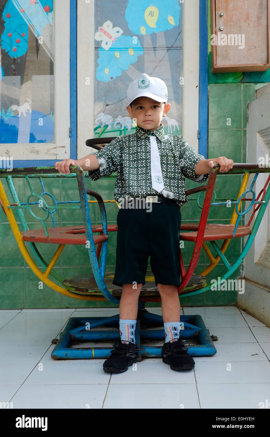 little indonesian schoolboy proudly posing in his school uniform in a ...