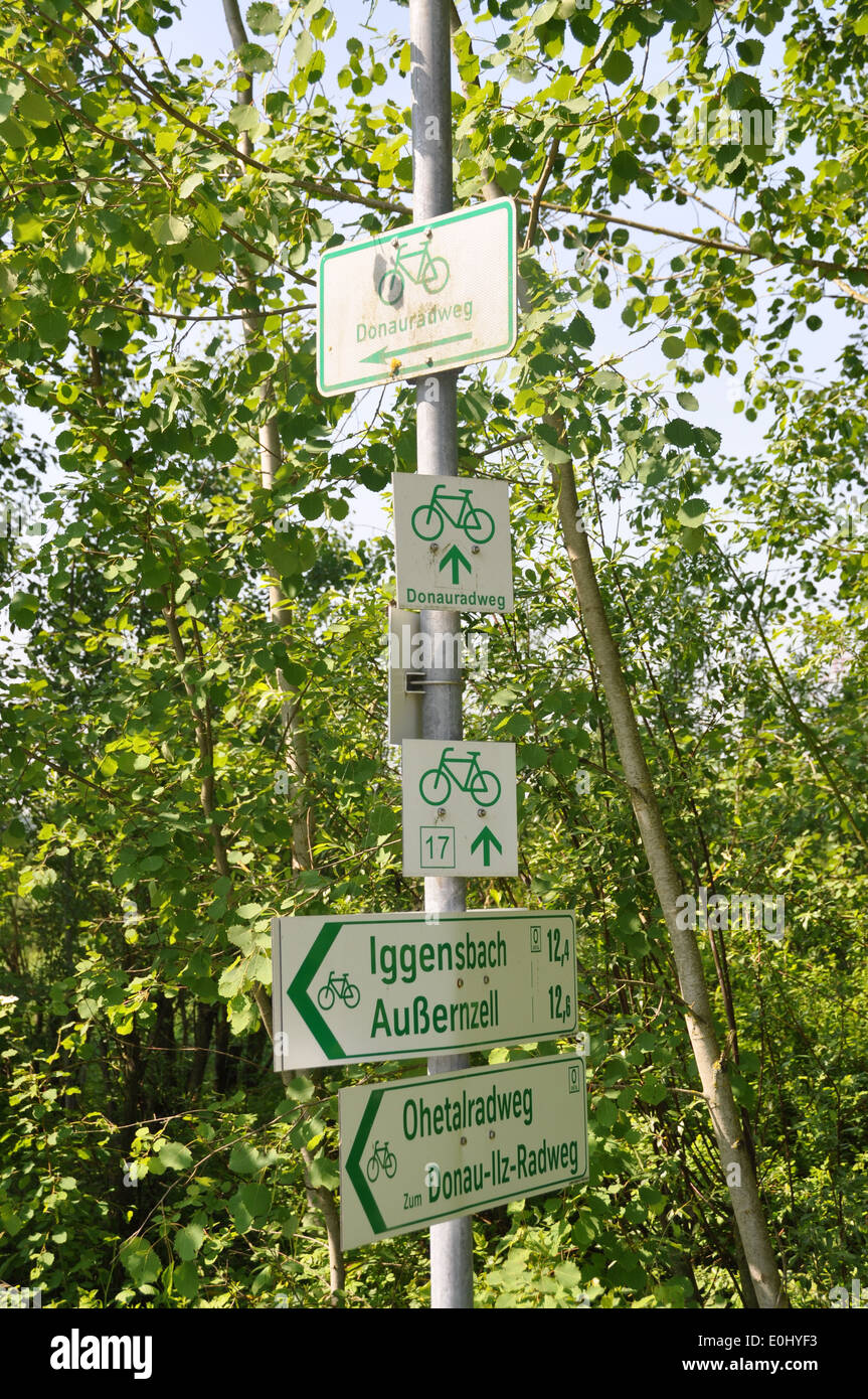 Six signs indicating different bike routes on a bike path alongside the ...