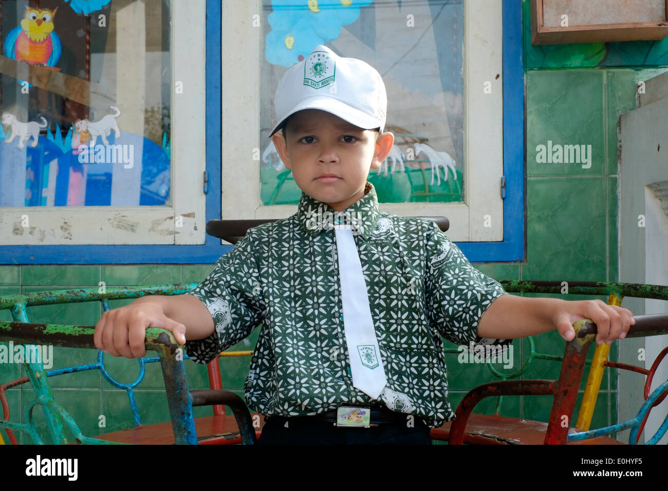little indonesian schoolboy proudly posing in his school uniform in a ...