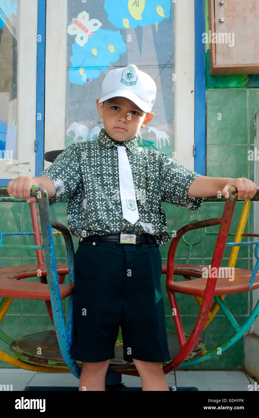little indonesian schoolboy proudly posing in his school uniform in a ...