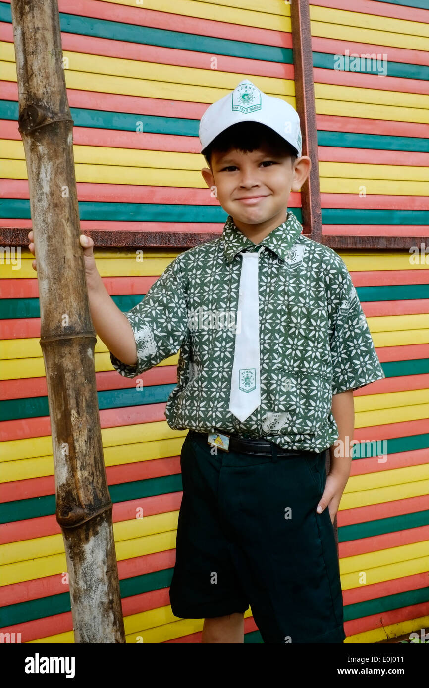 little indonesian schoolboy proudly posing in his school uniform in a ...