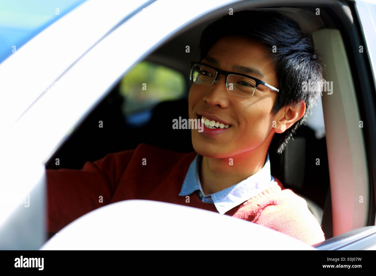 Handsome happy asian man sitting in car Stock Photo - Alamy