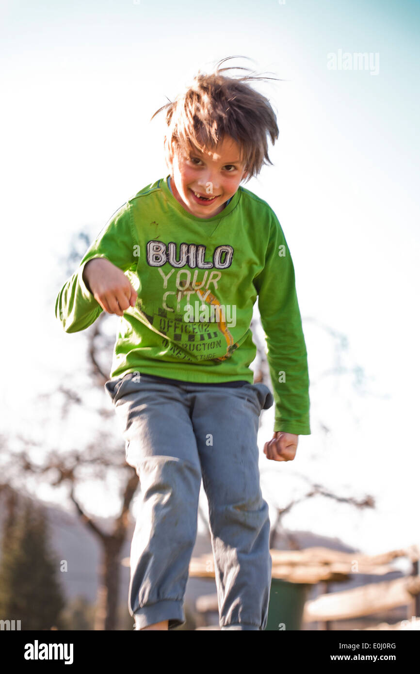 Boy playing outdoors Stock Photo - Alamy
