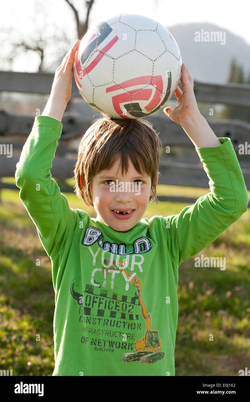 Boy playing football alone hi-res stock photography and images - Alamy