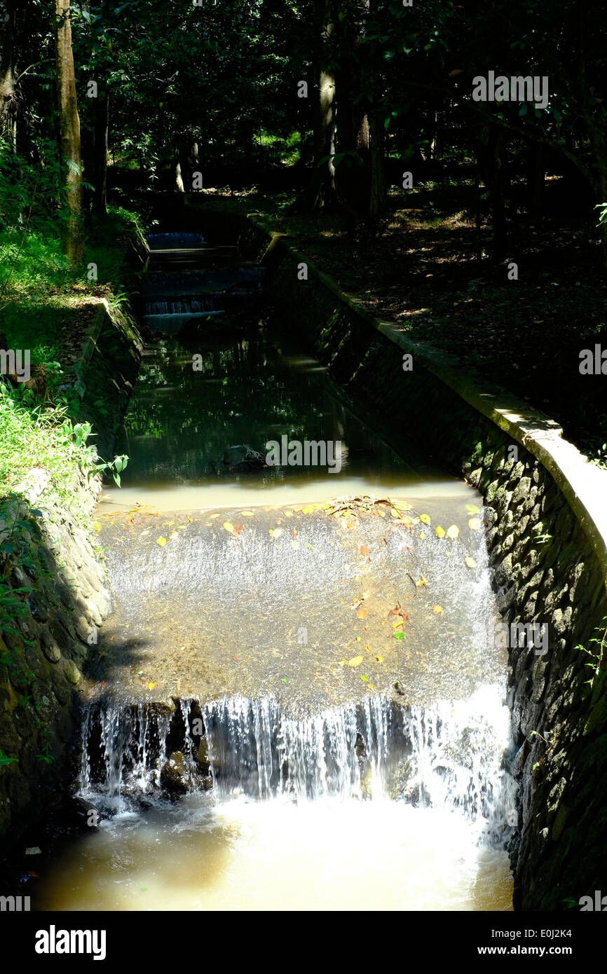 water flowing through a culvert at the purwodadi botanical gardens near ...