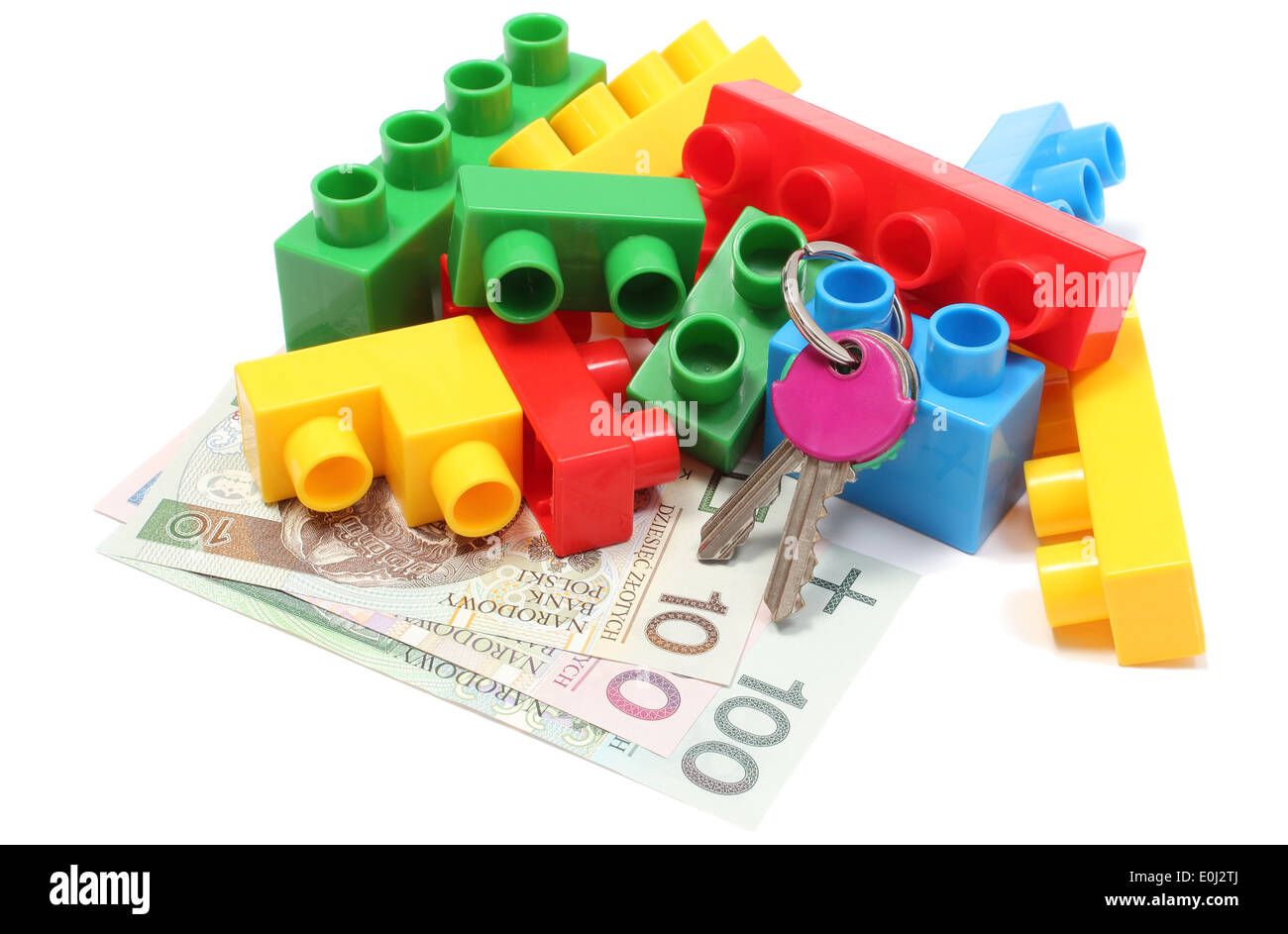 Closeup of home keys, heap of colorful building blocks and banknotes ...