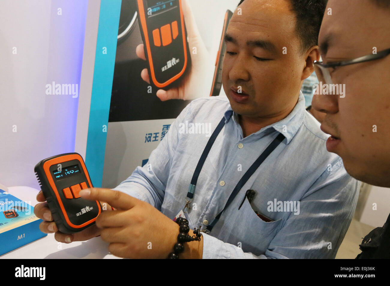 Beijing, China. 14th May, 2014. An exhibitor shows a smog tester at the ...