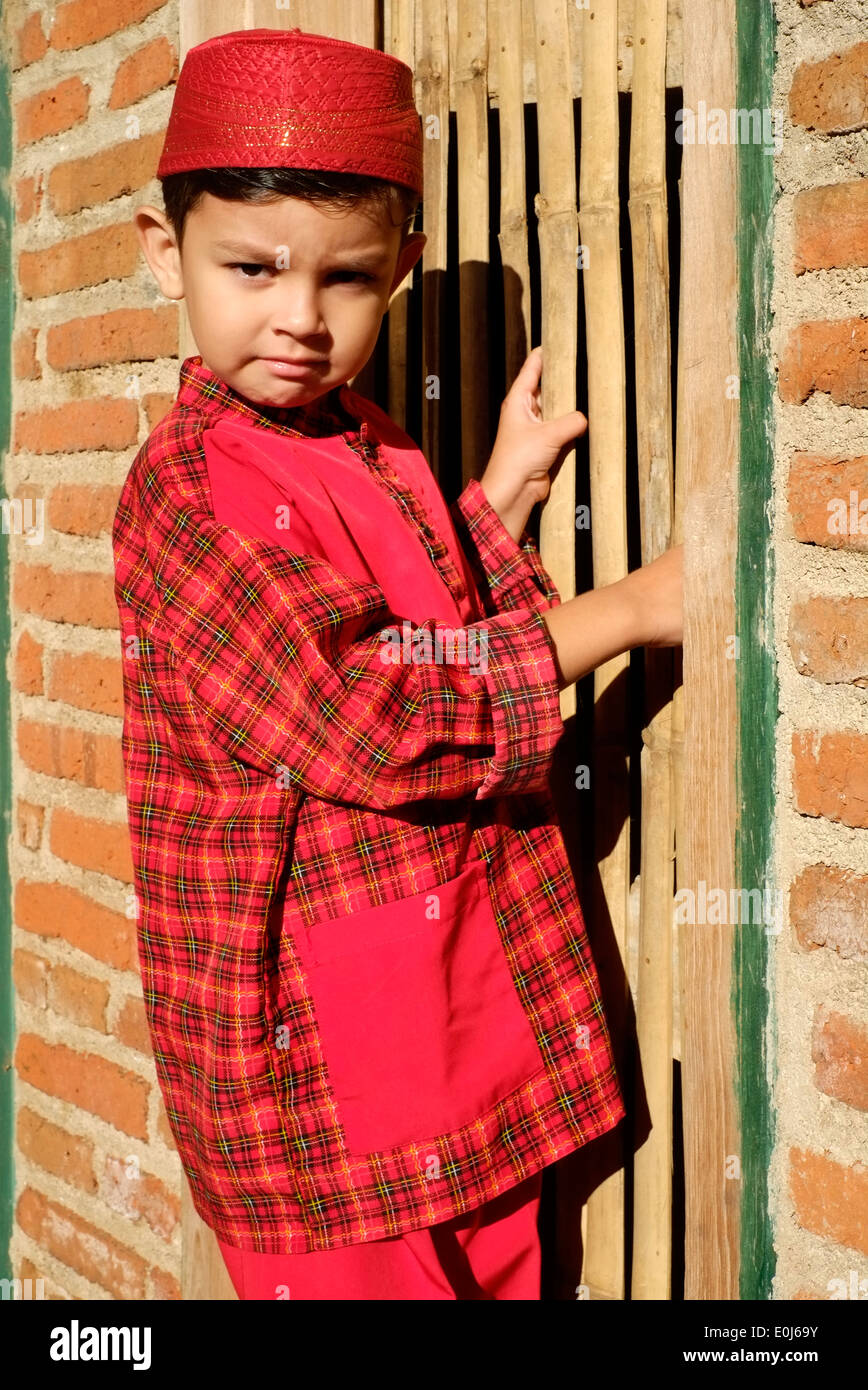 little indonesian schoolboy proudly posing in his school uniform in a ...