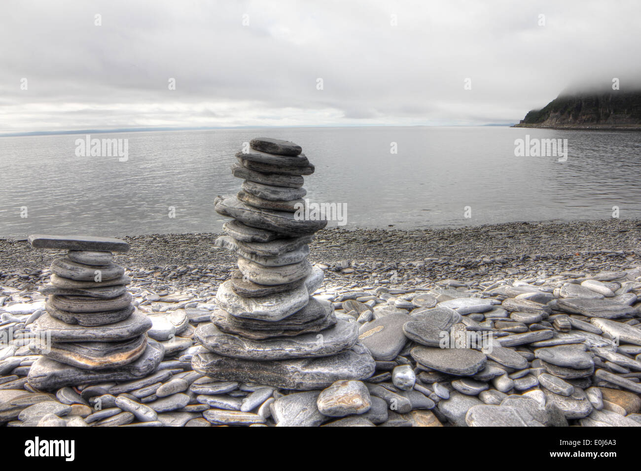 Stack of stones on northern Norway fjord background Stock Photo - Alamy