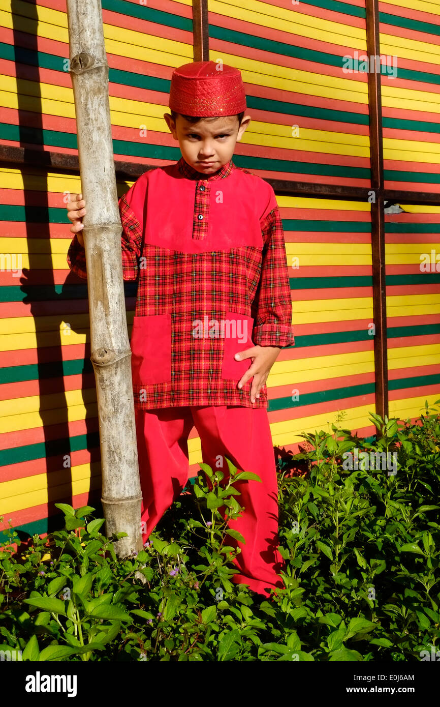 little indonesian schoolboy proudly posing in his school uniform in a ...