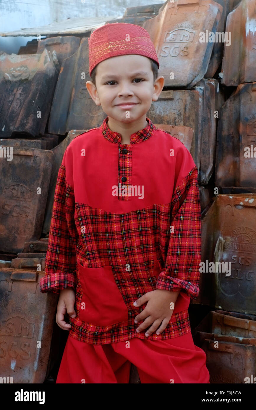 little indonesian schoolboy proudly posing in his school uniform in a ...