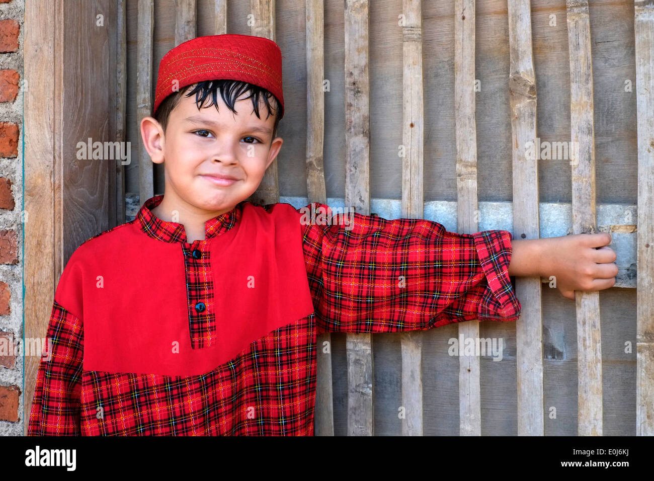 little indonesian schoolboy proudly posing in his school uniform in a ...
