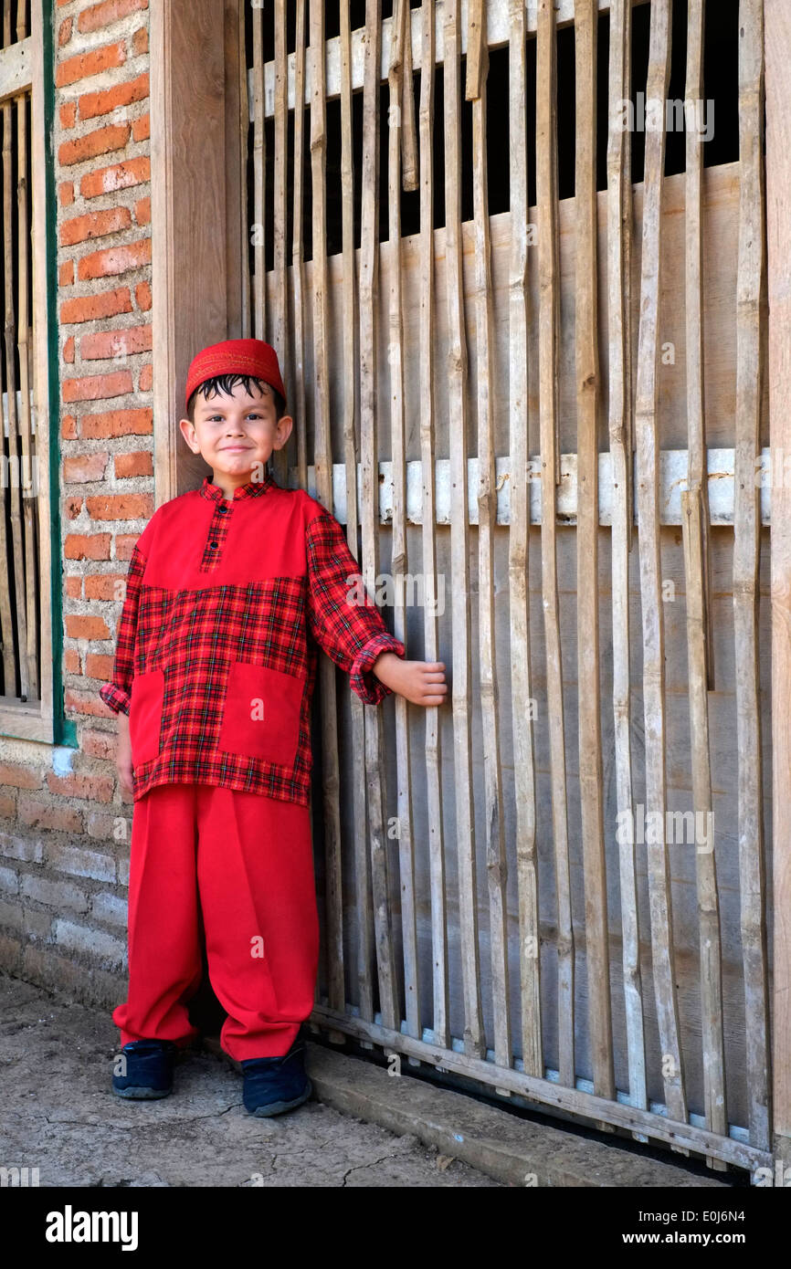 little indonesian schoolboy proudly posing in his school uniform in a ...