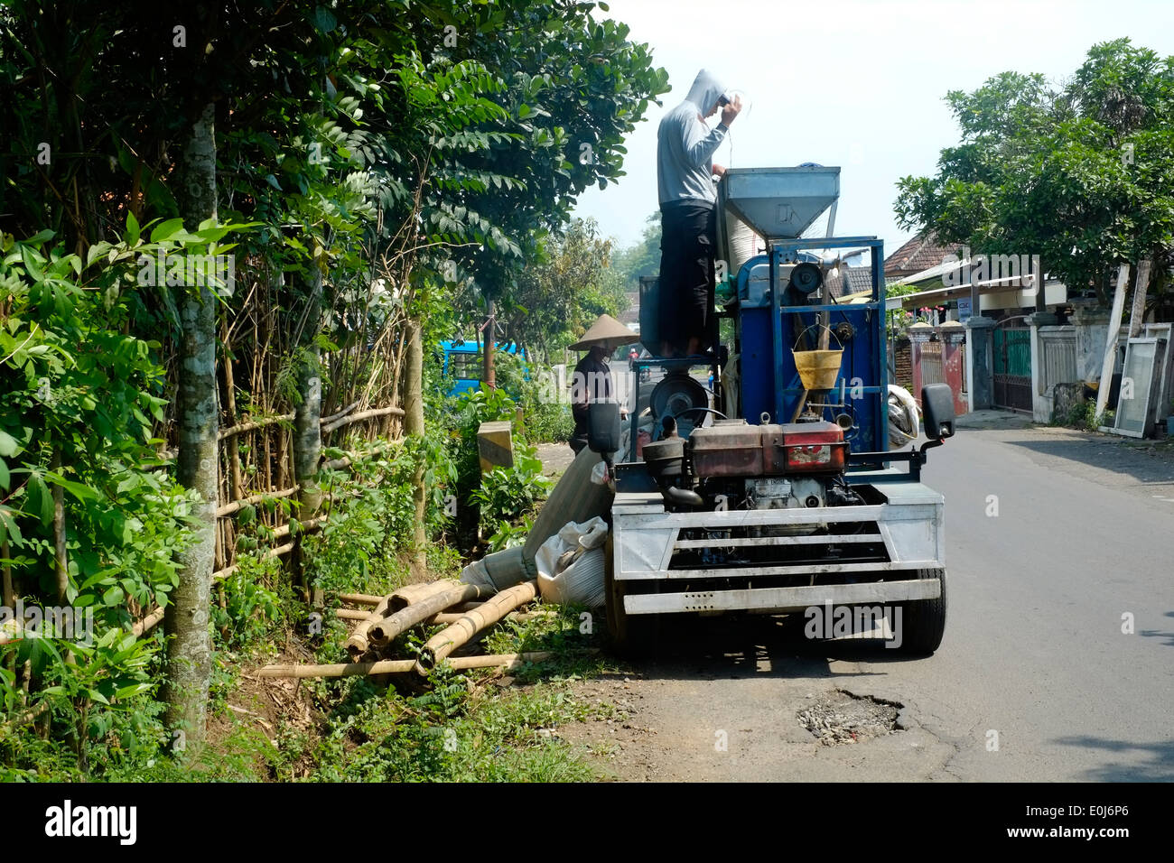 local men on a mobile rice sifting machine to sell rice to villagers in ...