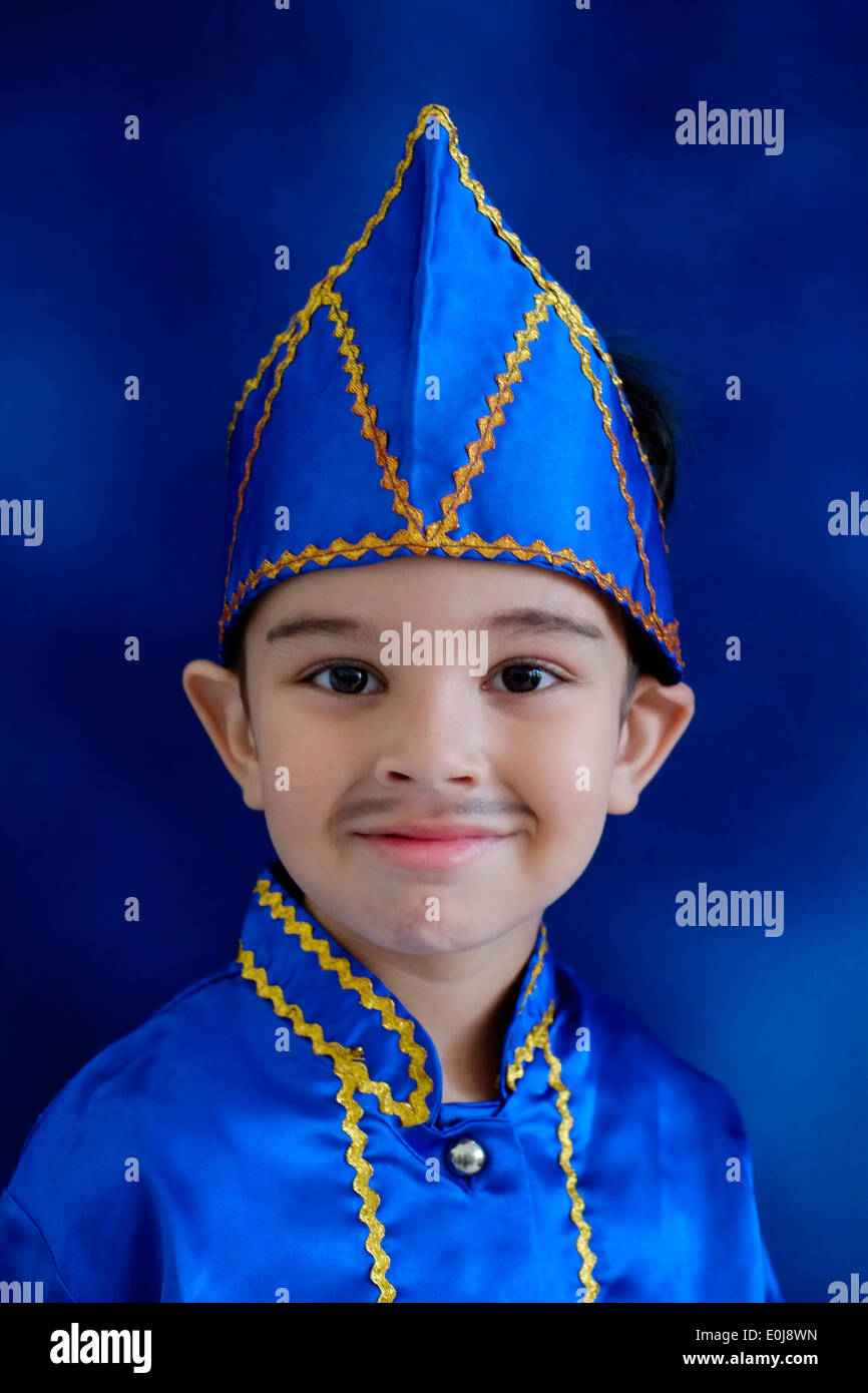 little boy poses in fancy dress at school to commemorate the indonesian ...