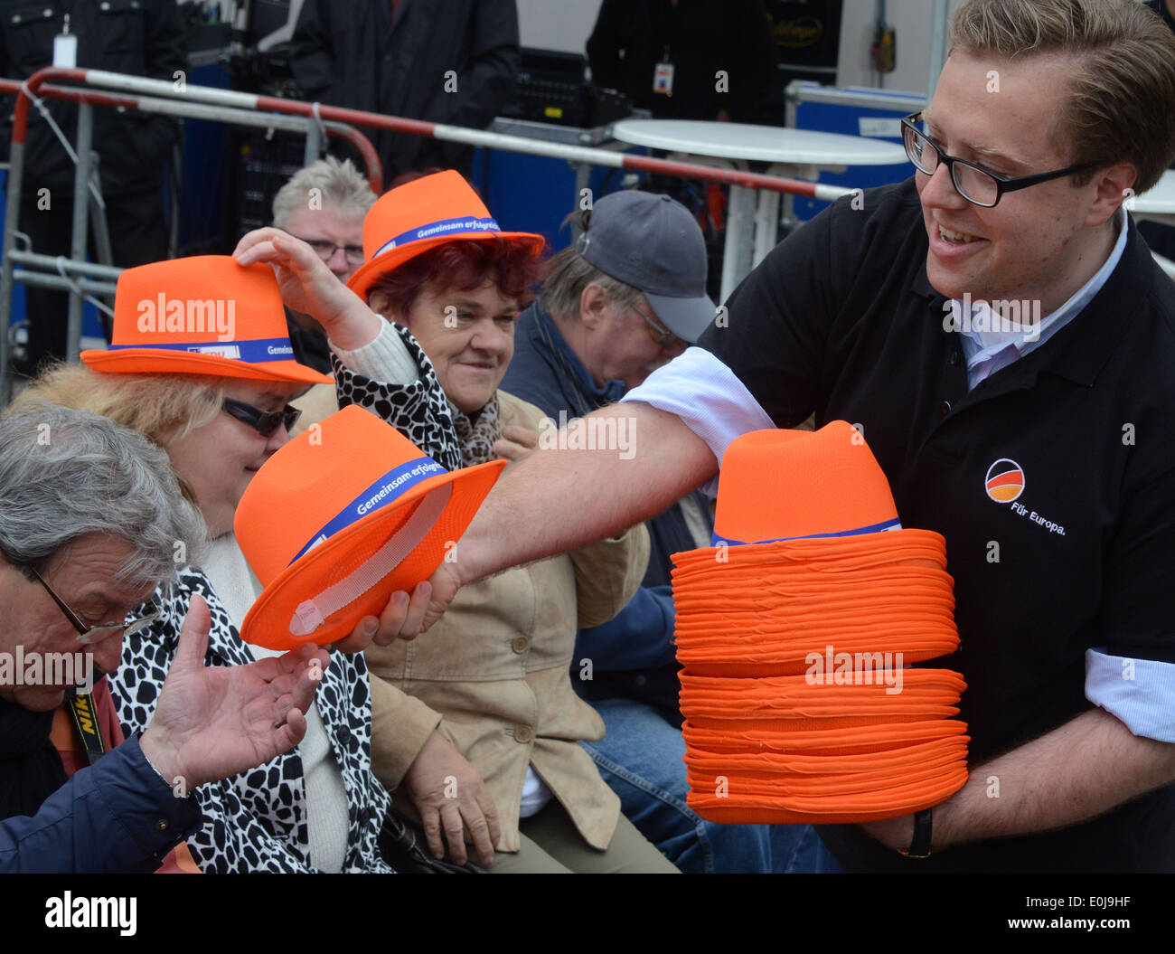 A man gives out orange hats prior to a pre-election event with German ...