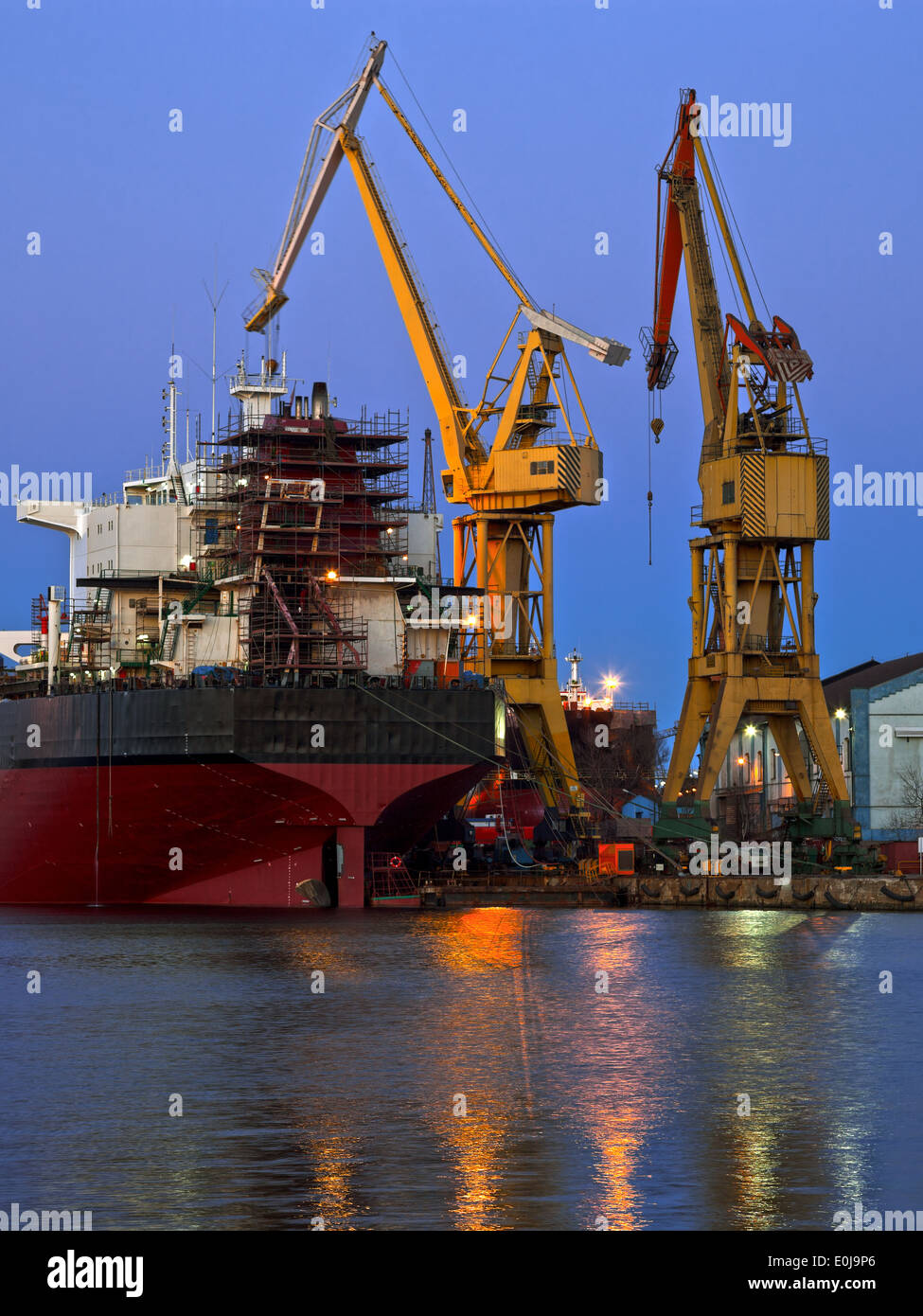 Industrial shipyard yellow crane at night Stock Photo - Alamy