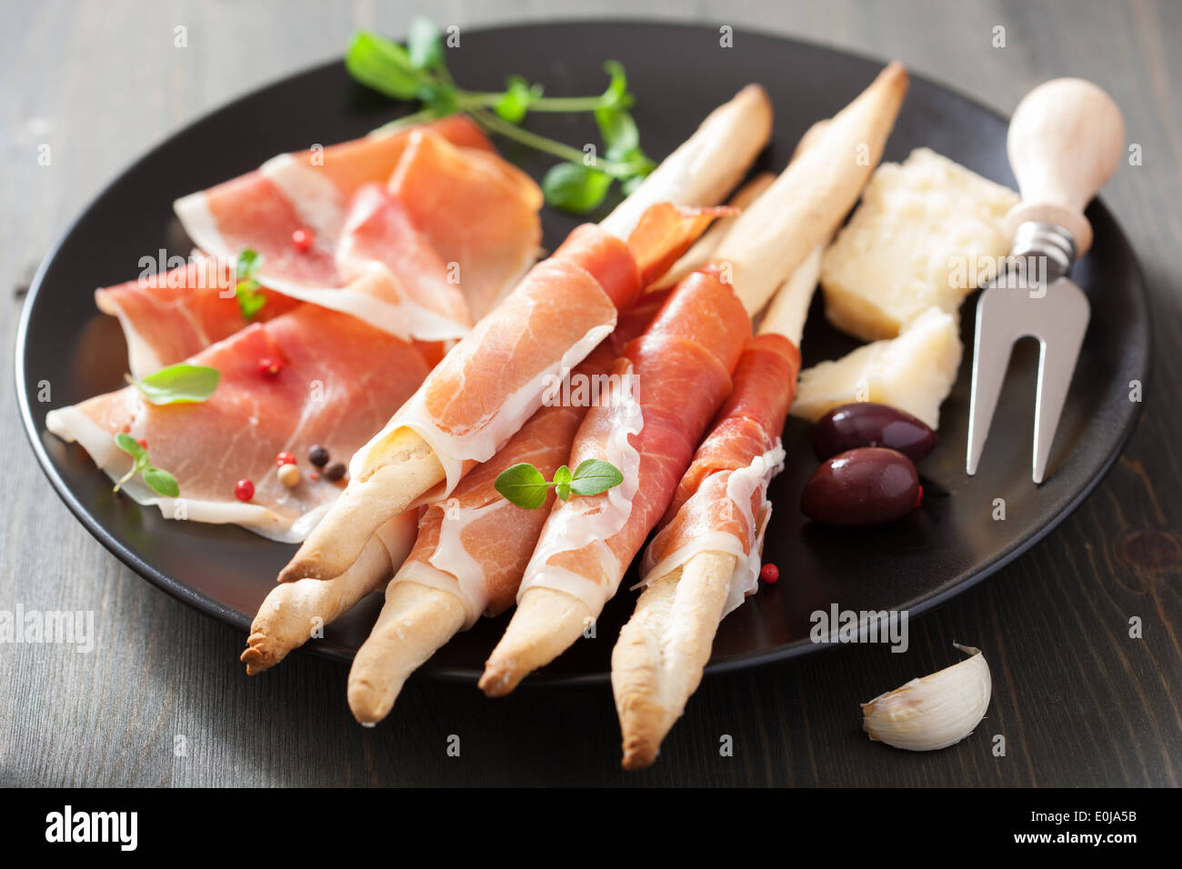 prosciutto ham and grissini bread sticks. italian antipasto Stock Photo ...