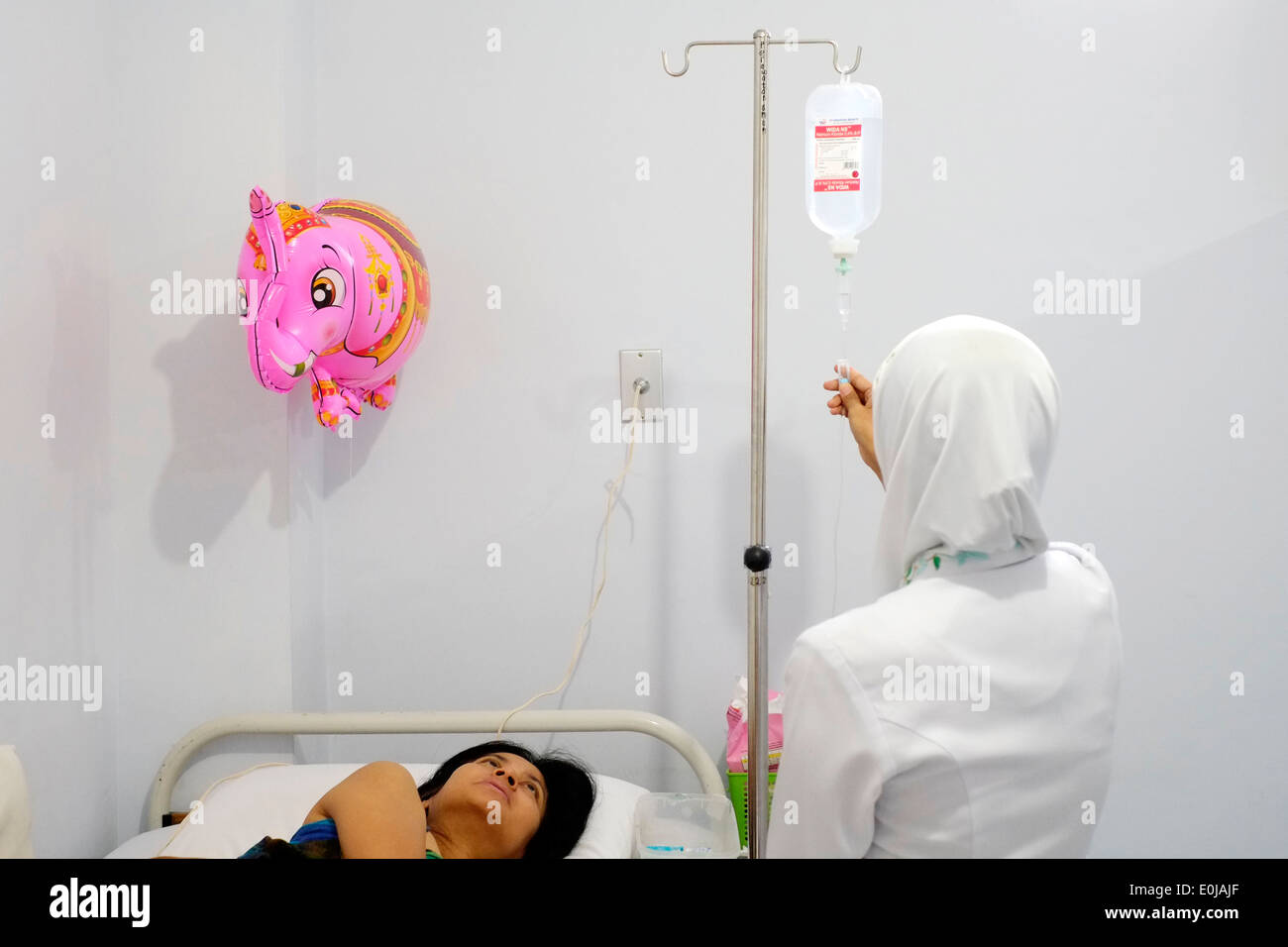 a nurse attending to a patient shortly after her cesarean c section ...