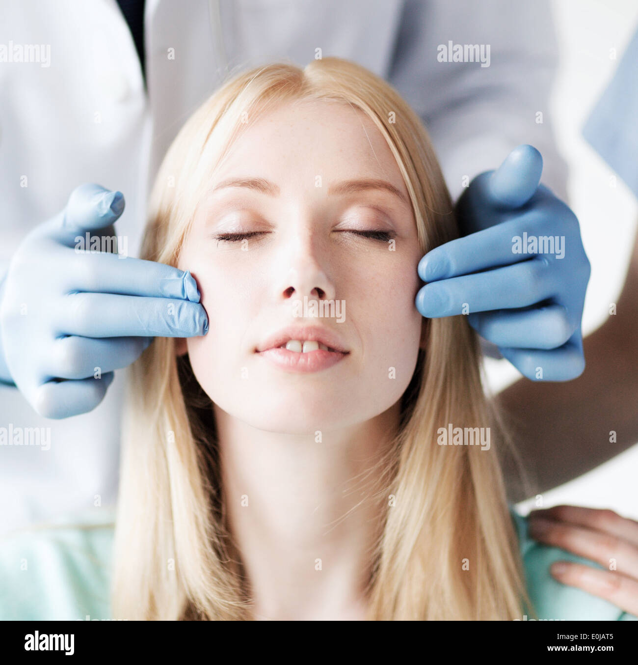 plastic surgeon and nurse with patient Stock Photo - Alamy
