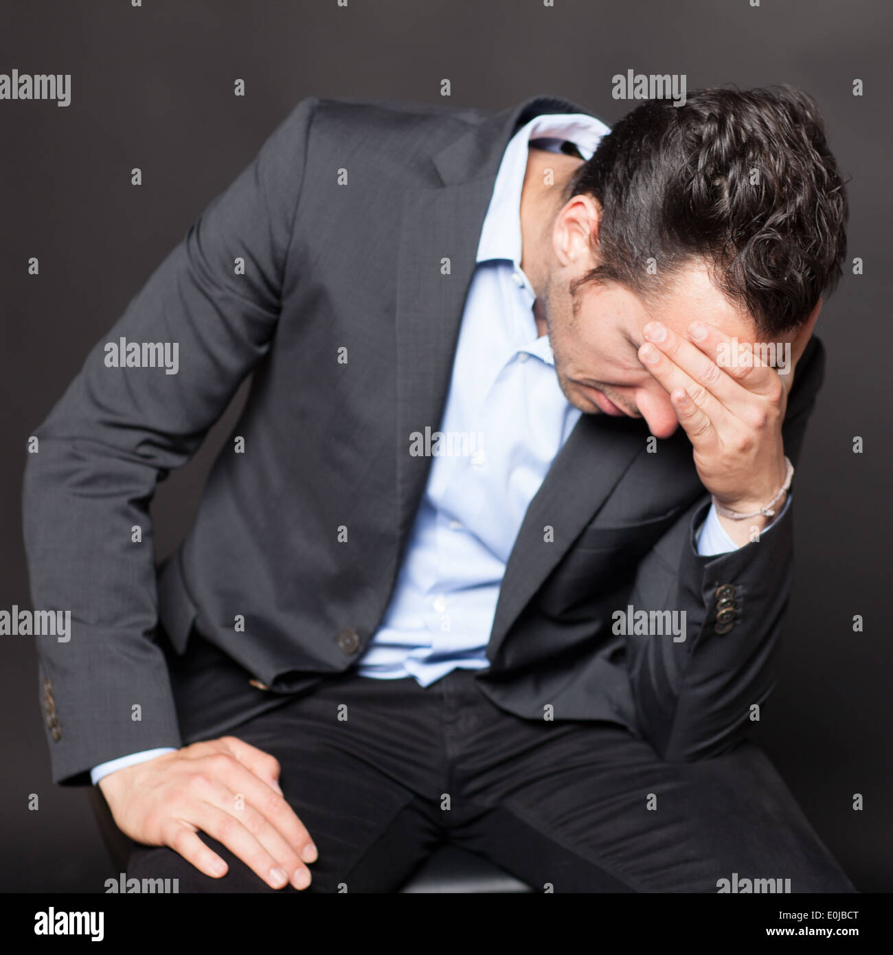 Depressed man on black background Stock Photo - Alamy