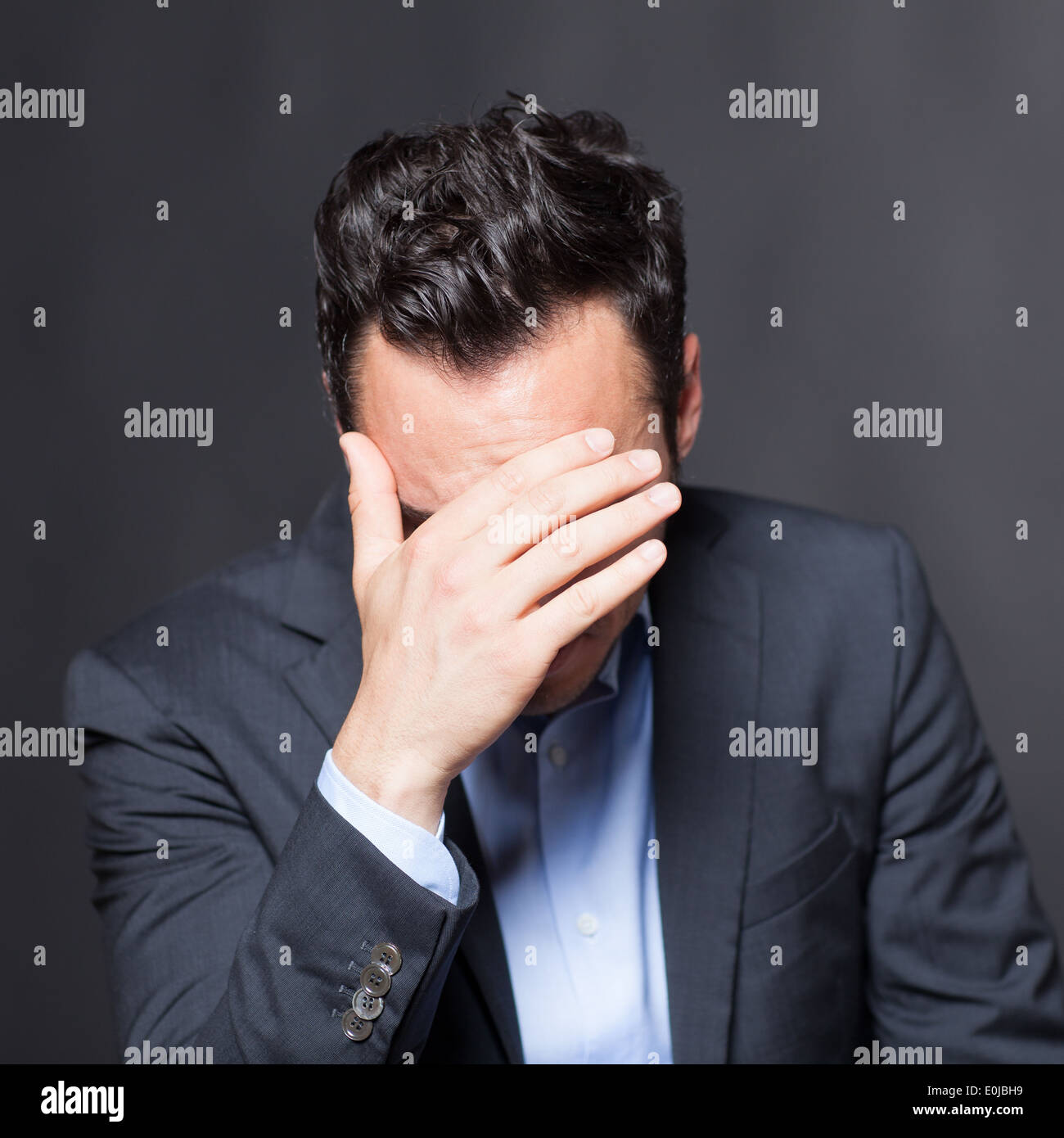 Depressed man on black background Stock Photo - Alamy