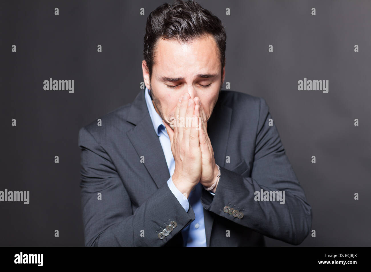Depressed man on black background Stock Photo - Alamy