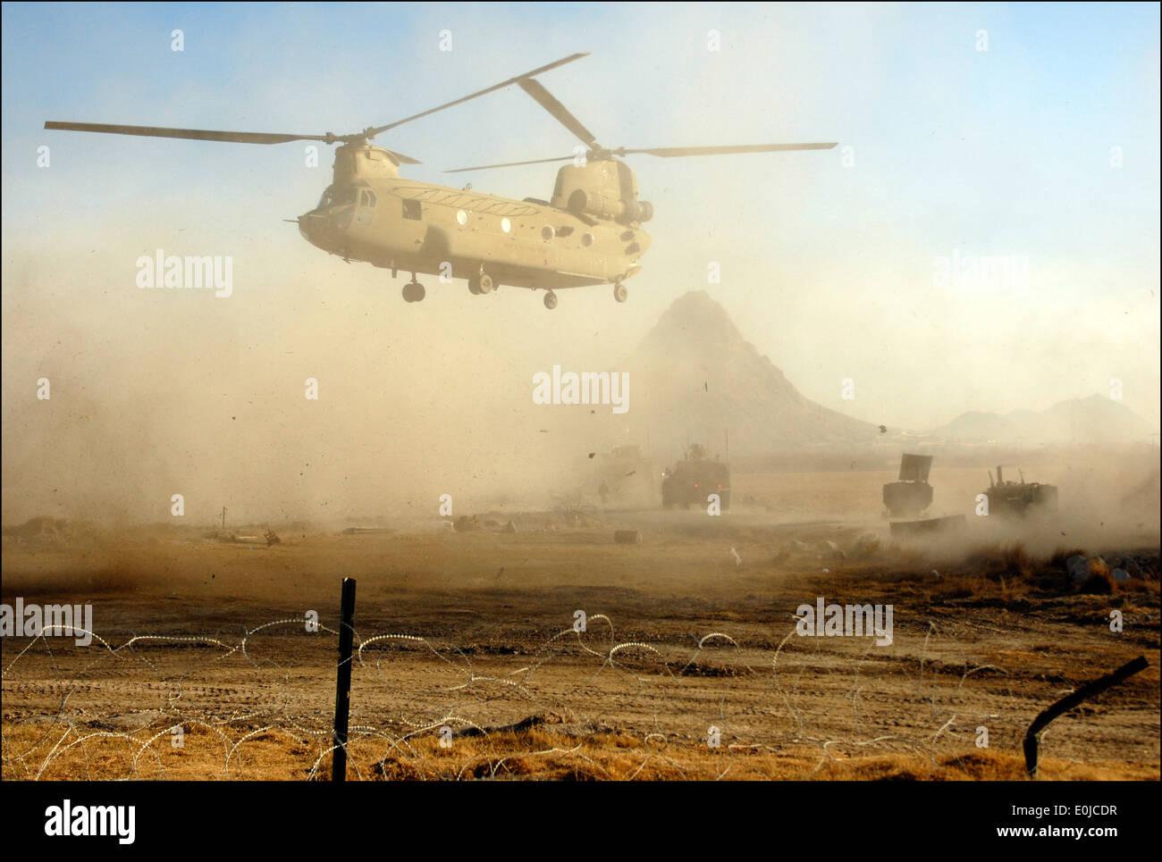 A Chinook helicopter passes over an International Security Assistance ...
