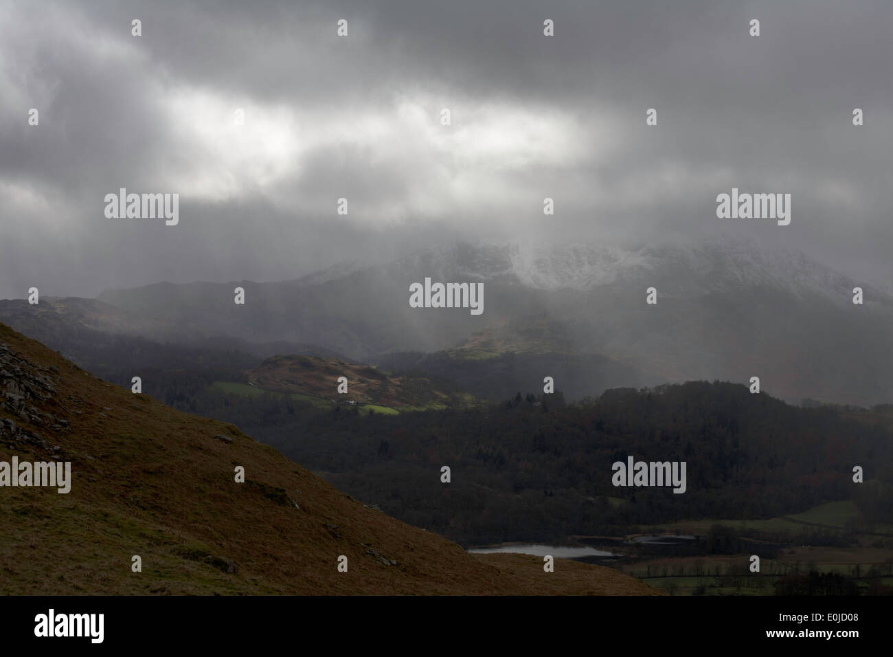 Storm clouds and snow over Wetherlam and The Old Man of Coniston from ...