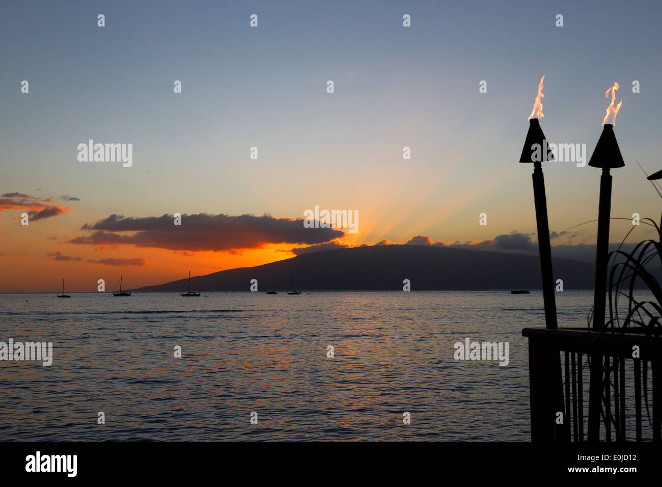 Tiki torches and sunset on Maui, Hawaii Stock Photo - Alamy