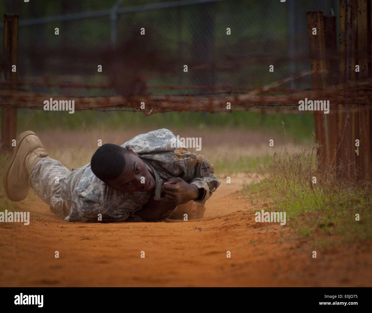 Spc. David Jackson low crawls under barbed wire during USACPOC(A)'s ...