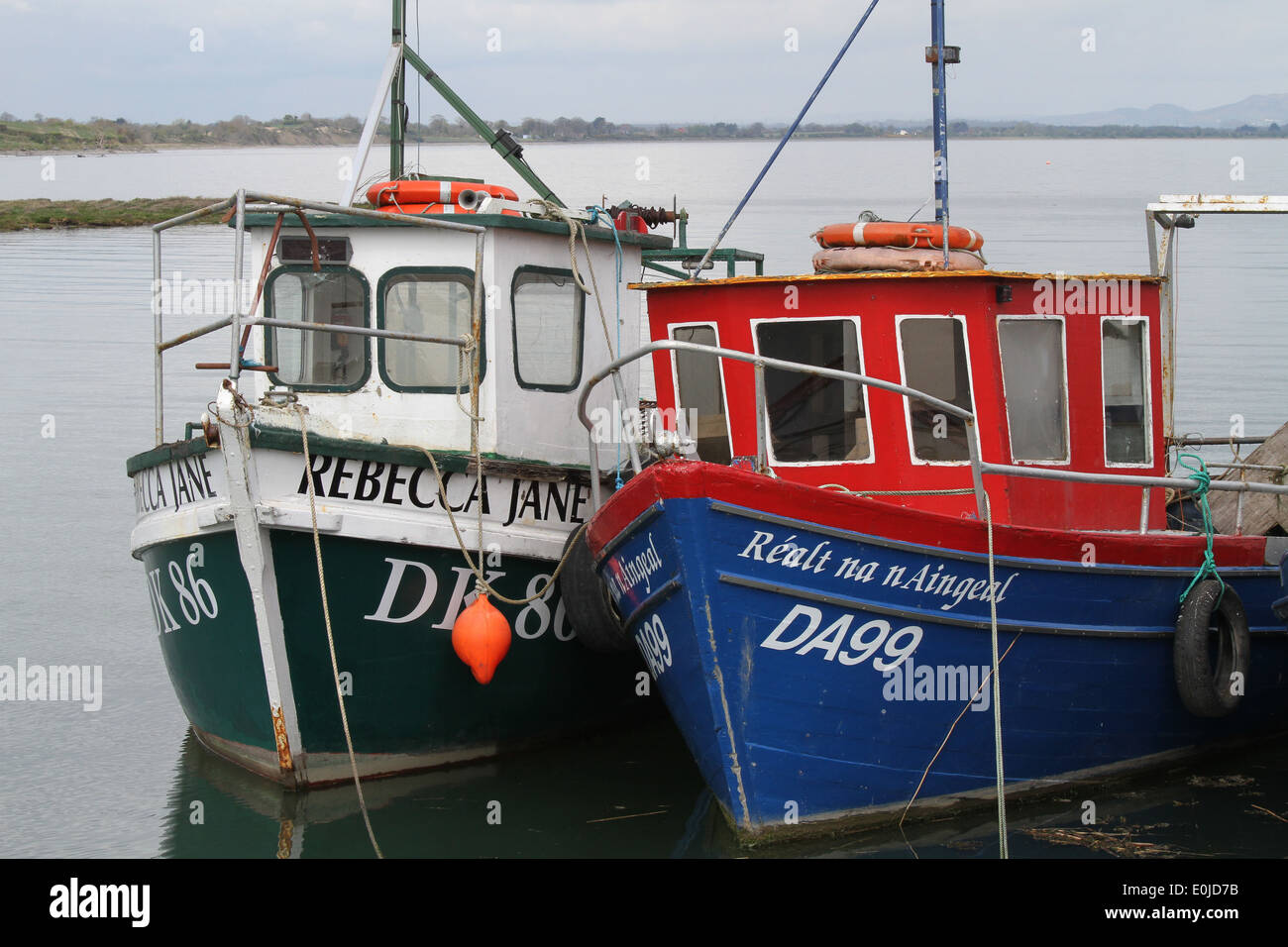 Small brightly-coloured fishing boats in the small harbour at village ...