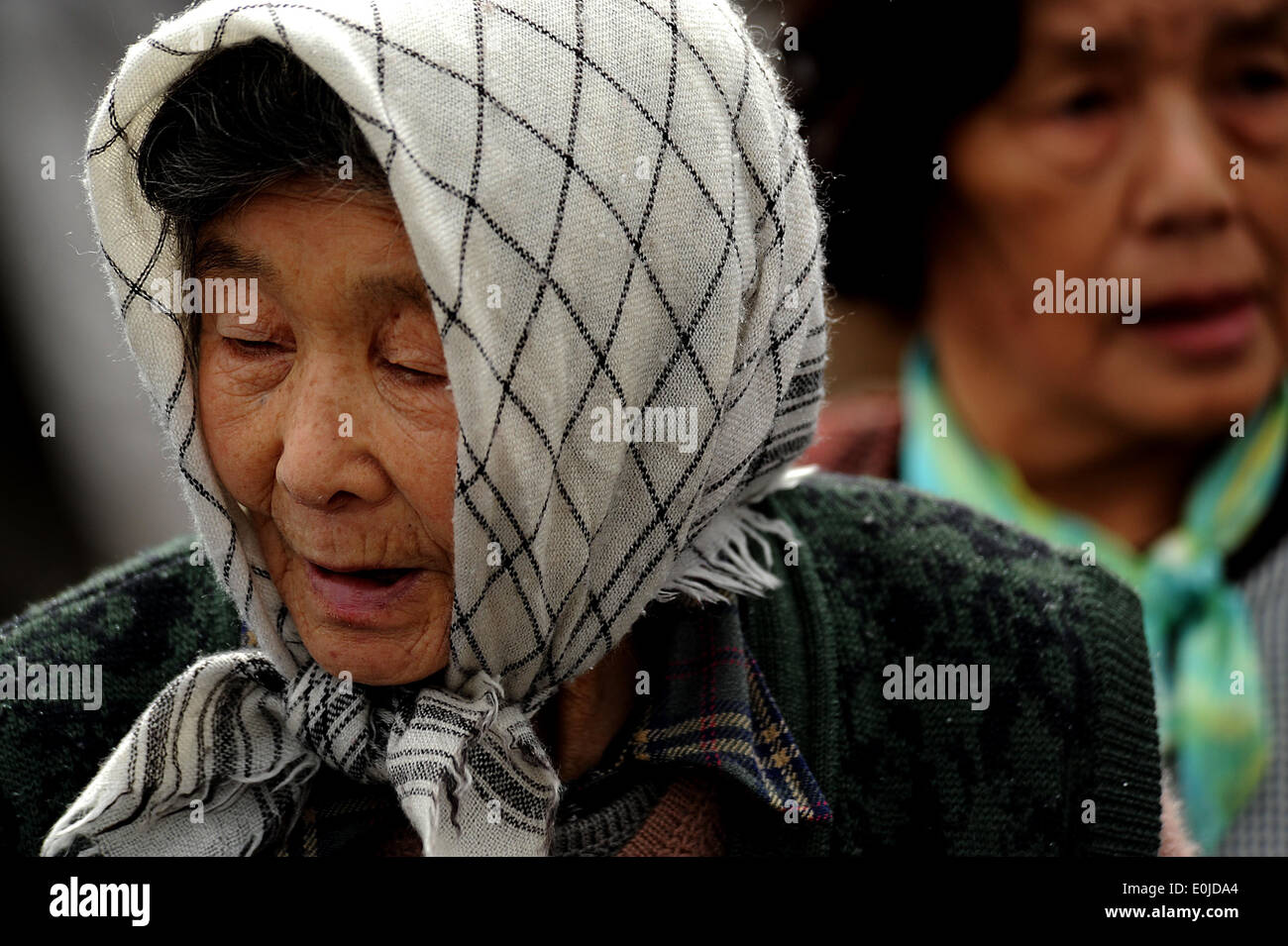 Local Japanese stand in line with their containers to receive clean ...