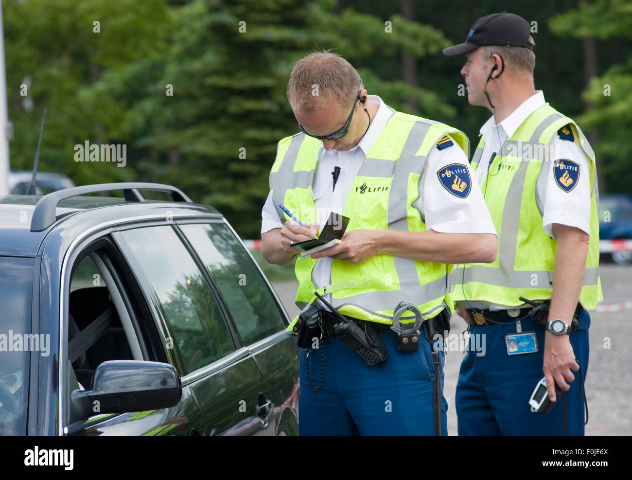 A policeman is writing a ticket for a car driver who was speeding Stock ...