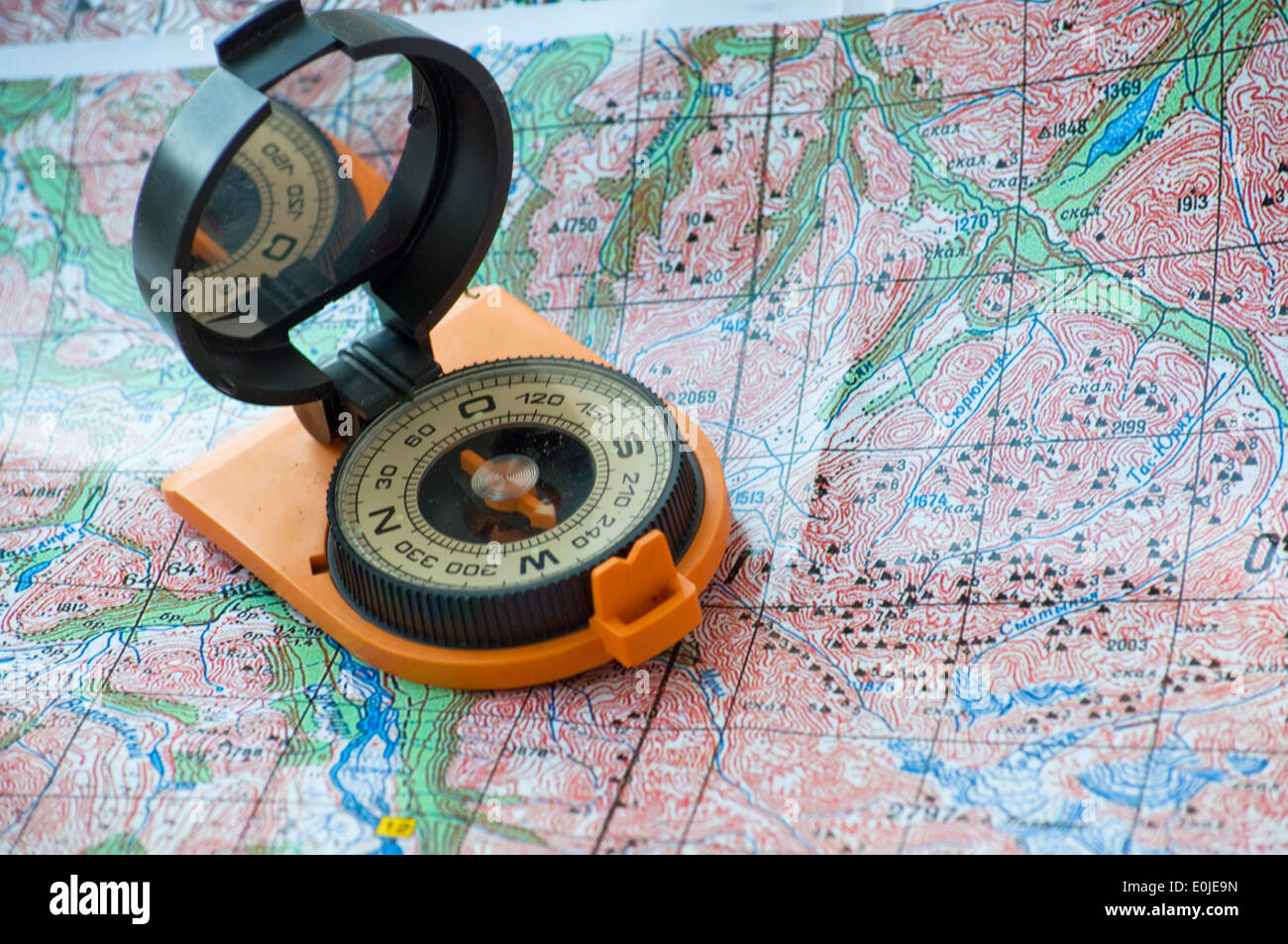 Magnetic compass in a red-black housing, equipped with a mirror, is on ...