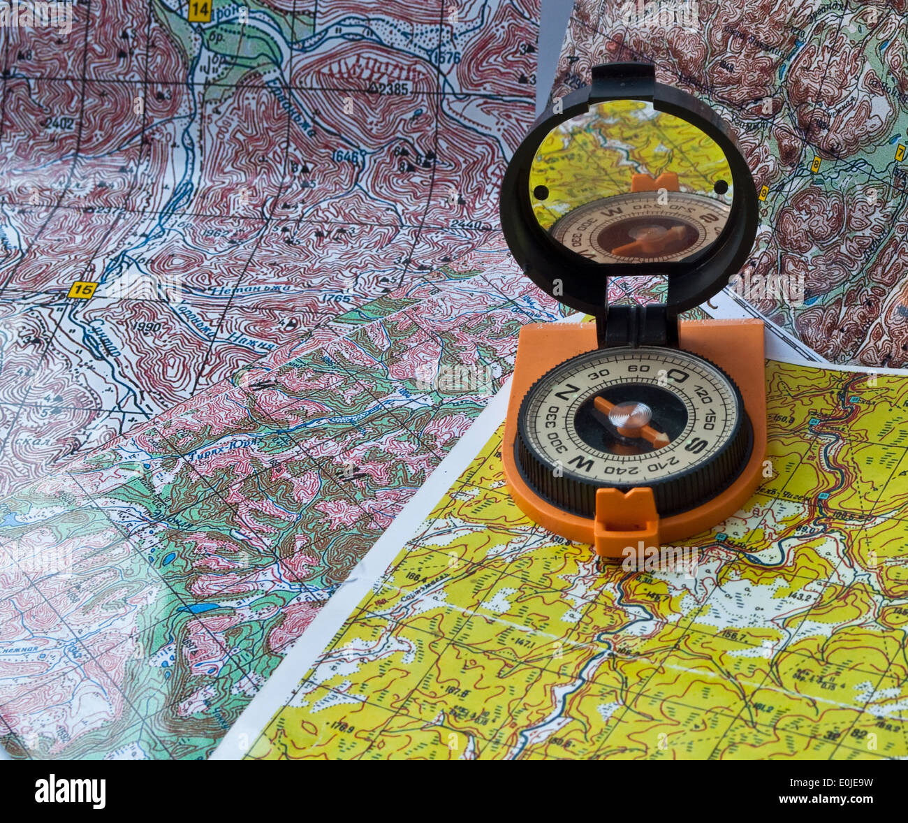 Magnetic compass in a red-black housing, equipped with a mirror, is on ...