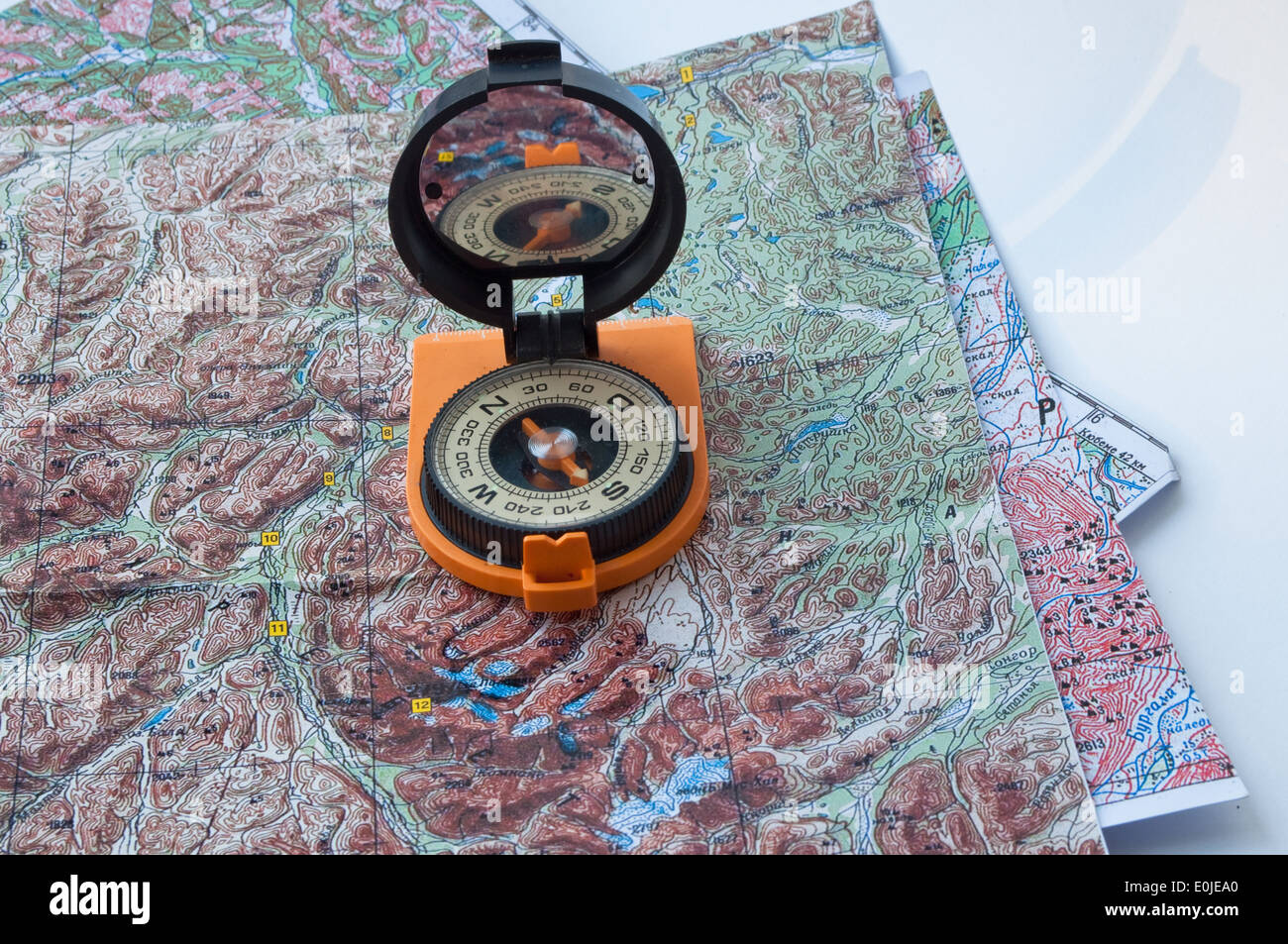 Magnetic compass in a red-black housing, equipped with a mirror, is on ...