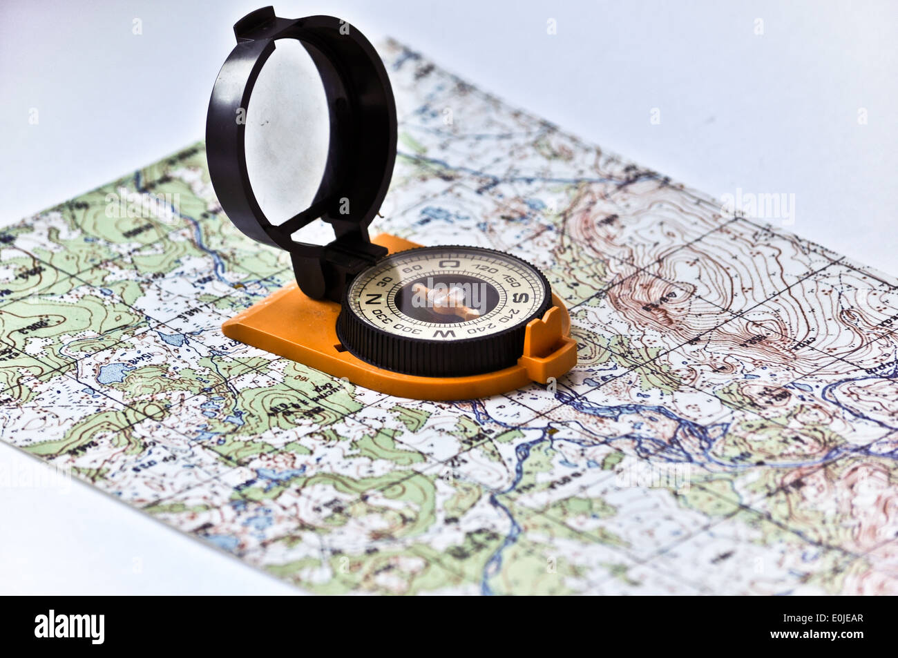 Topographic map lies on a white background, and there is a magnetic ...