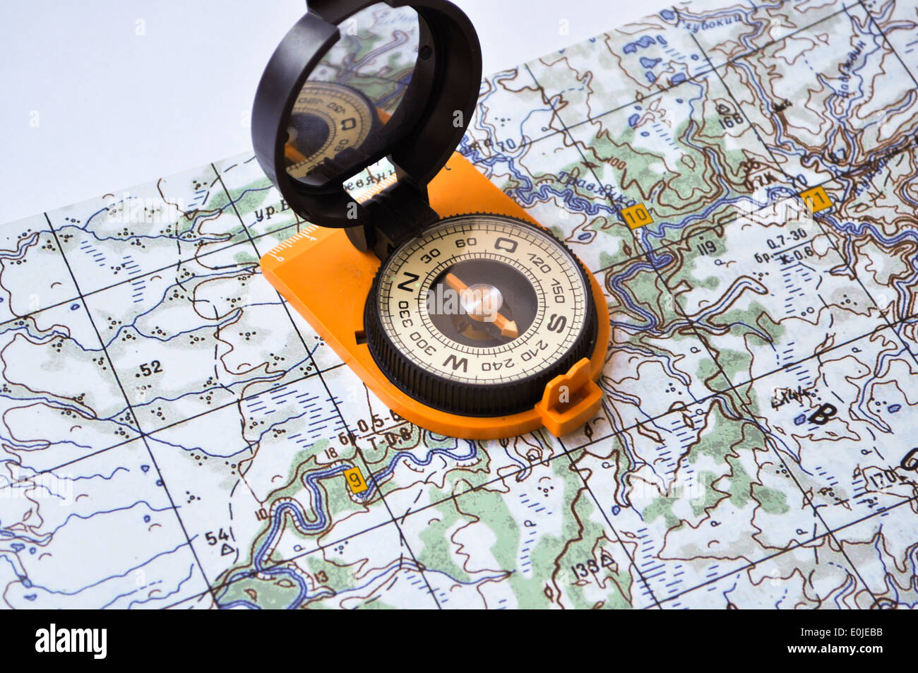 Topographic map lies on a white background, and there is a magnetic ...