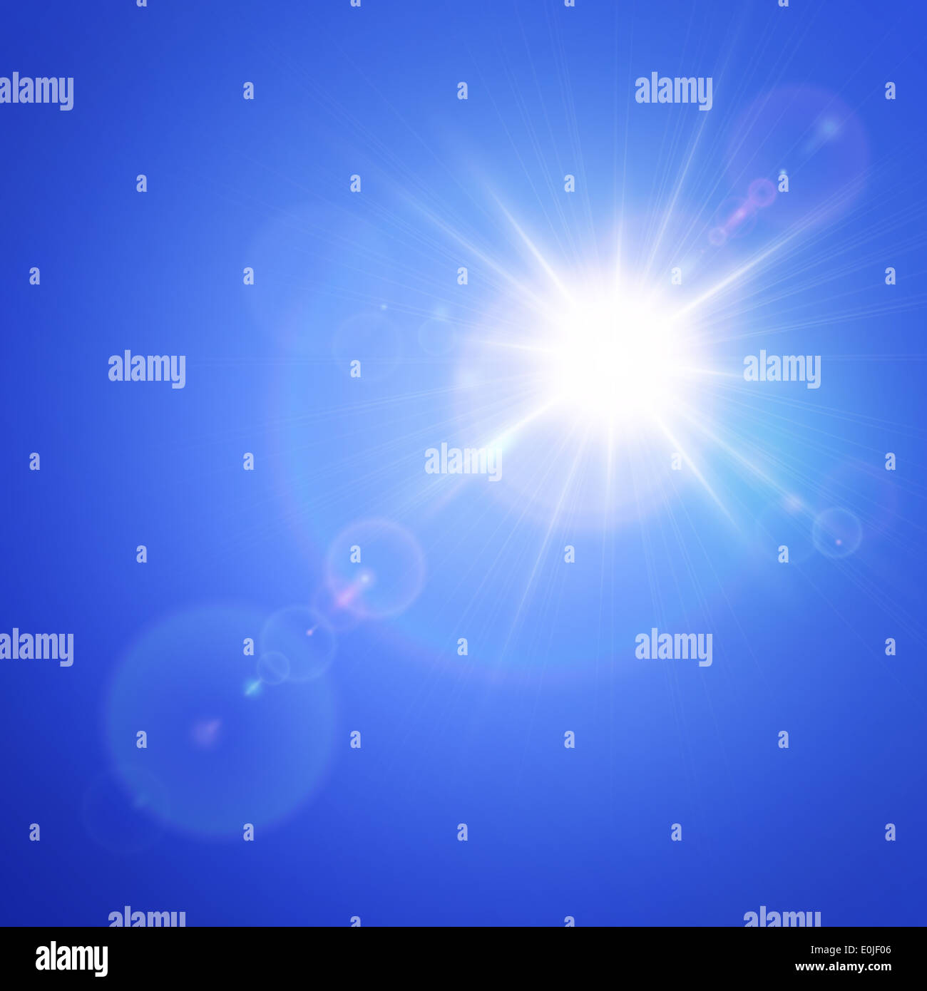 Bright sun in blue sky with lens flare effect Stock Photo - Alamy