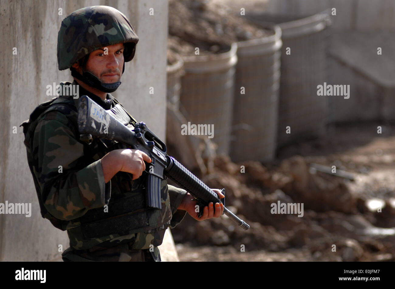 A 205th Corps Afghan National Army soldier stands guard at his post in ...